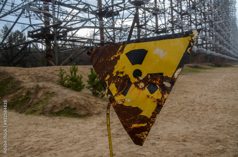 Rusty yellow radioactive warning sign near duga radar complex in the ...