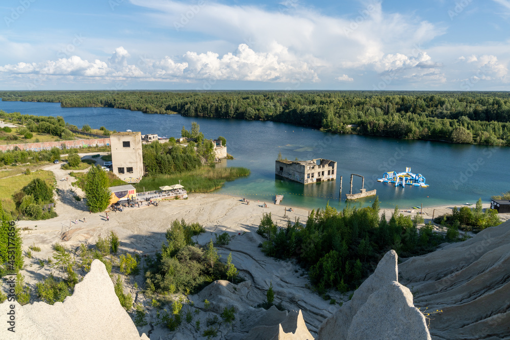 limestone mountains and calm blue groundwater lake in an old quarry ...