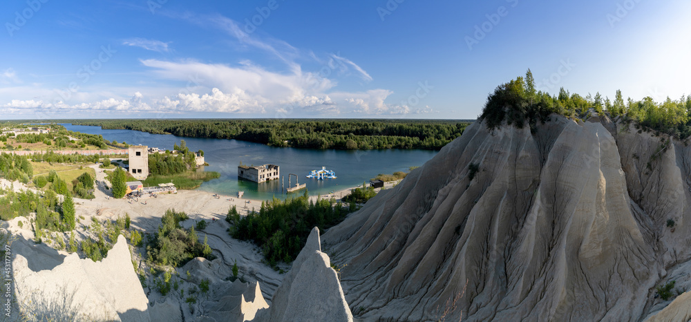 limestone mountains and calm blue groundwater lake in an old quarry ...