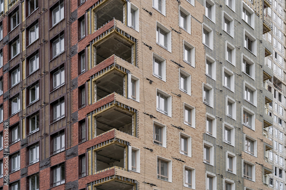 Facing building with ventilated facade. Modern facades of high-rise ...