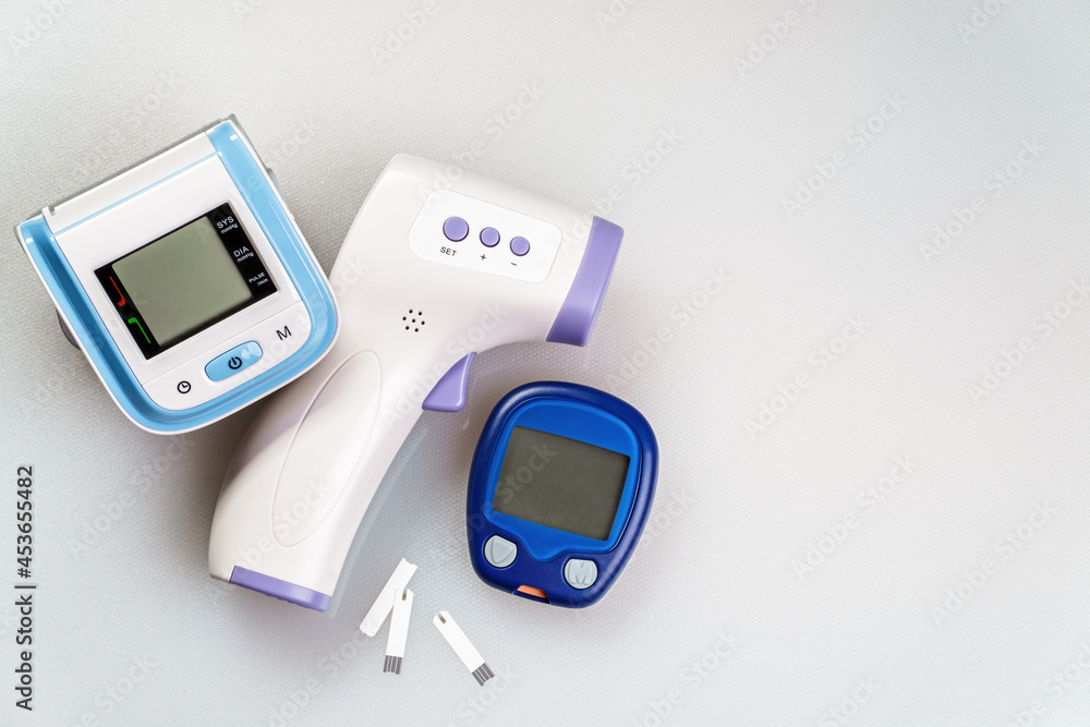 Essential home medical devices. Remote thermometer, blood glucose meter ...