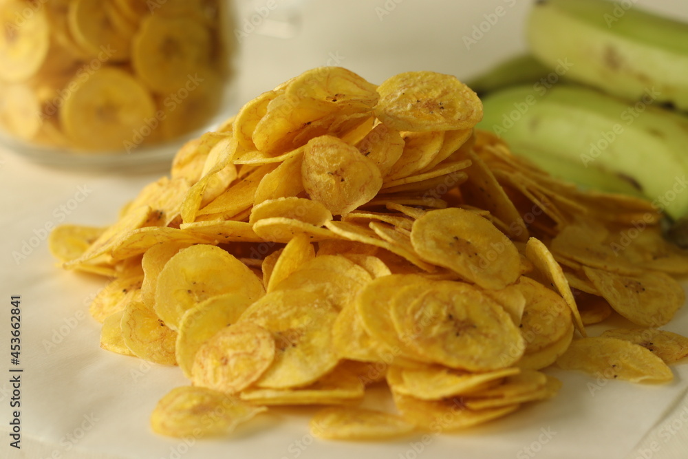 Fried banana chips made by deep frying under ripe banana slices. A main ...