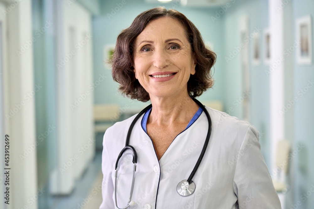 Portrait of smiling older senior female professional doctor physician ...