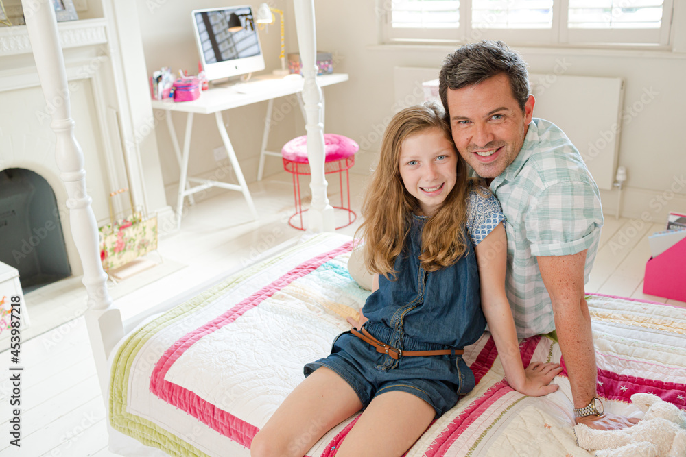 Father and daughter hugging on bed Stock Photo | Adobe Stock