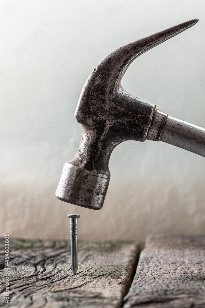mallet hammer hit nail. carpenter uses a hammer to hit the nail on the ...
