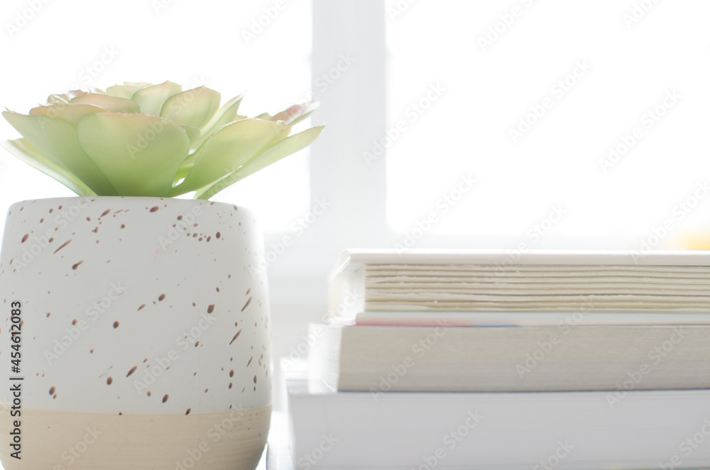 Books on the desk with white background, light colors, neutral colors ...