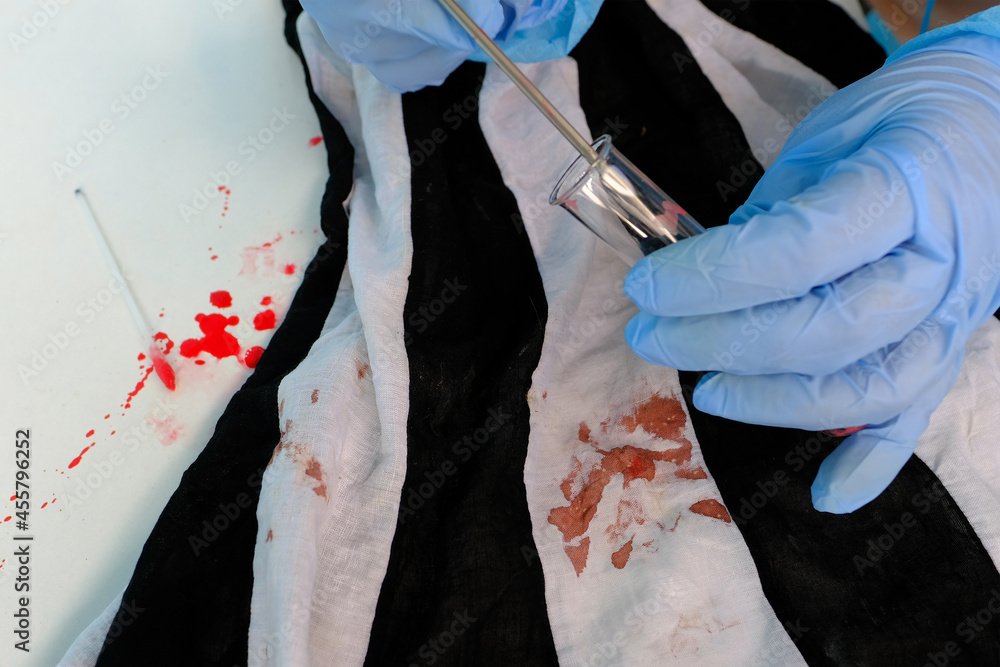 fresh splatter of blood on white table, stains on tissue at crime scene ...