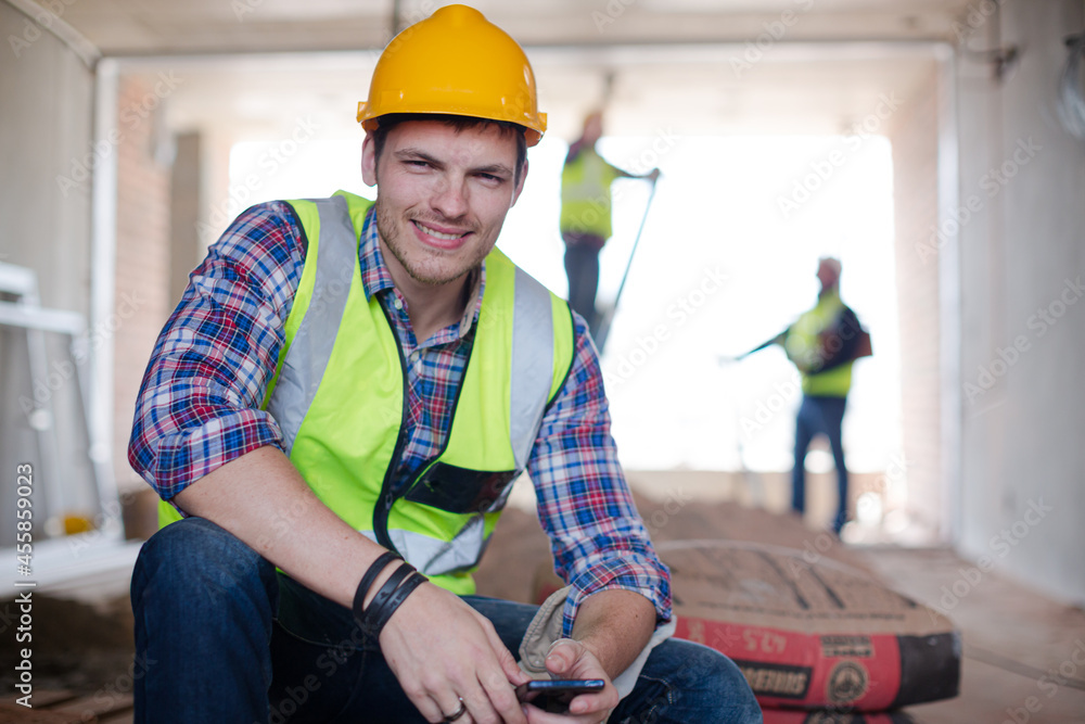 Construction workers using cell phone at construction site Stock Photo ...