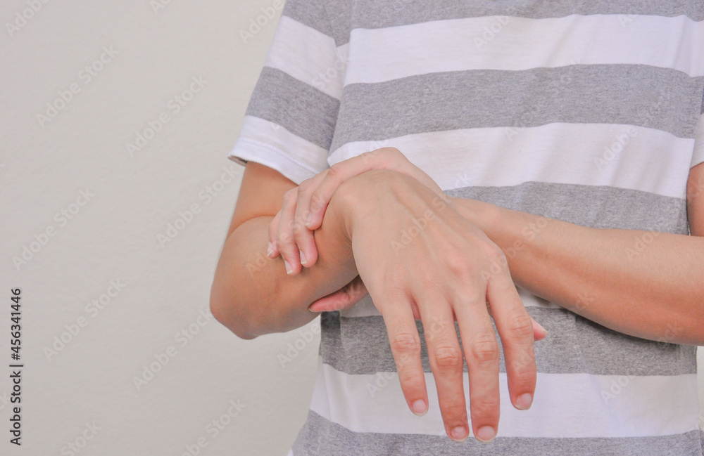 a man support his arms (selective focus) which pain,numbness,weakness ...
