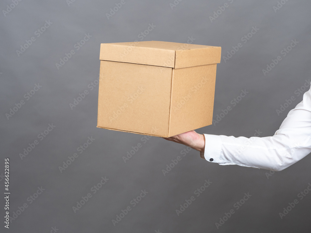 Cardboard packaging. Man's hand shows box. Concept - packaging ...