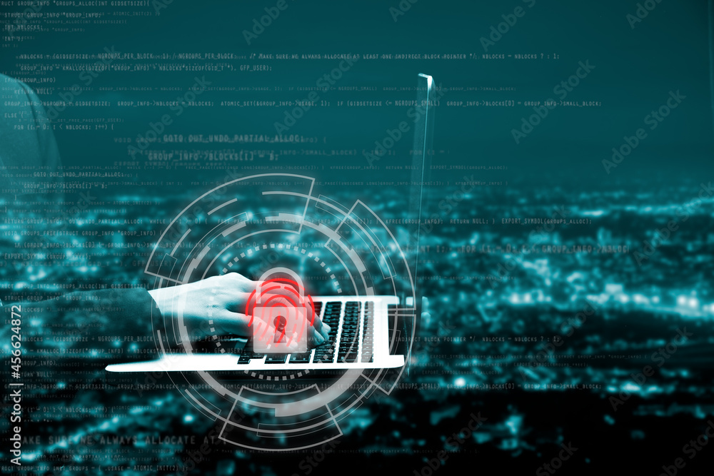 Hacker hand using keyboard typing bad data into laptop computer online system and spreading to ...