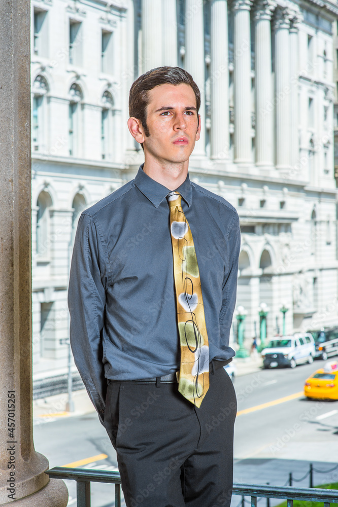 Dressing in a blue shirt, black pants, a colorful tie, hands putting in ...