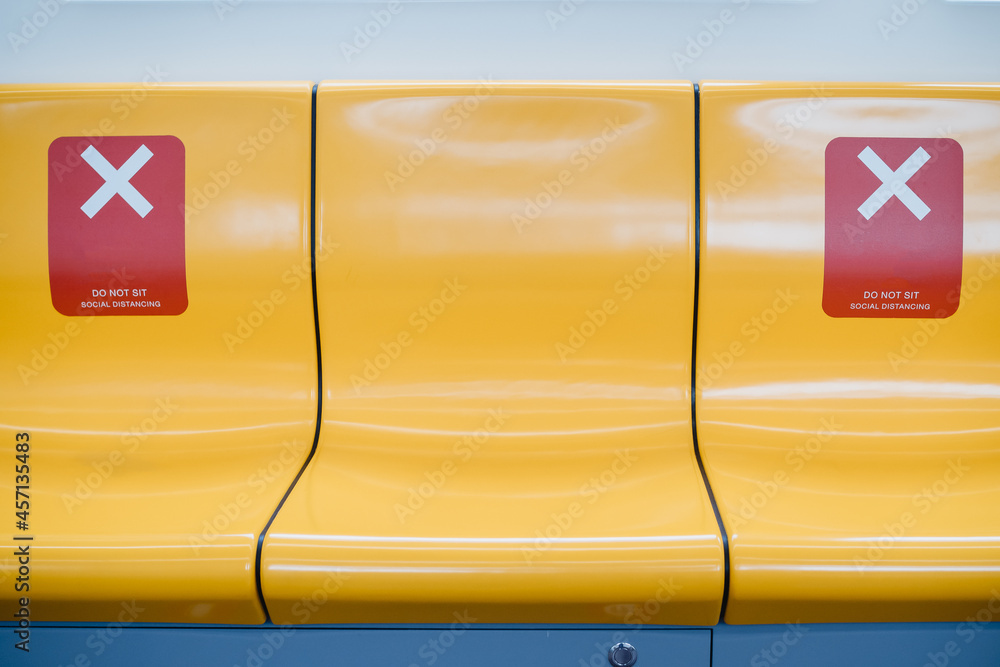 The yellow chair on the subway train and prohibition sign for social ...