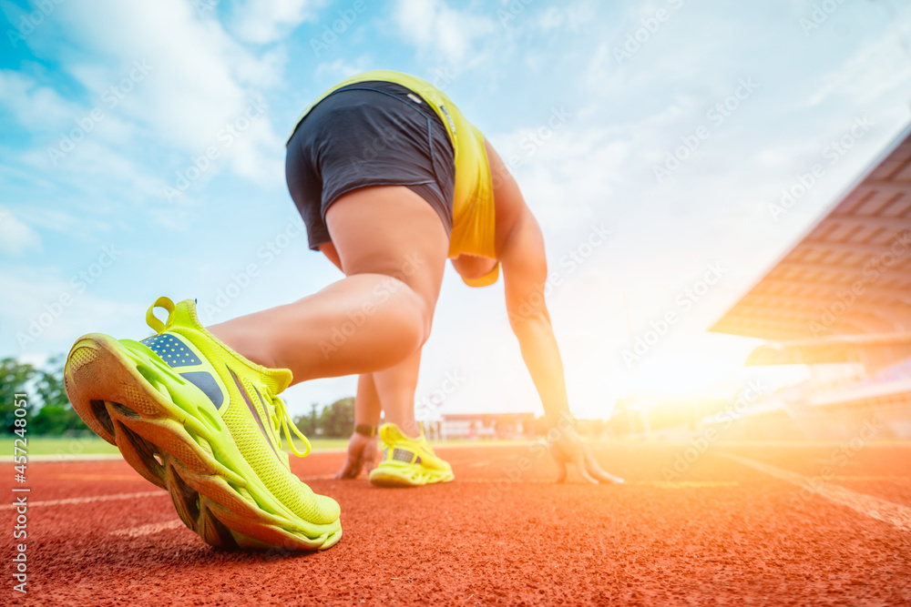 Runner using starting block to start his run on race track. Athlete ...