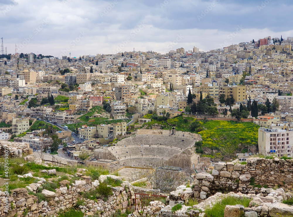 City of Amman surrounds ancient amphitheater and ruins, Jordan Stock ...