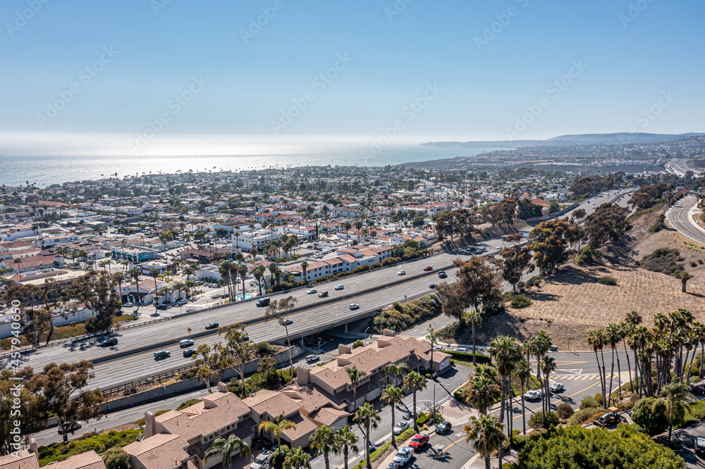 Aerial view of a coastal community with the ocean and freeway visible ...