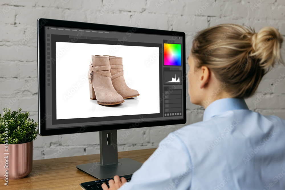 woman doing product photo editing on desktop computer in office Stock ...