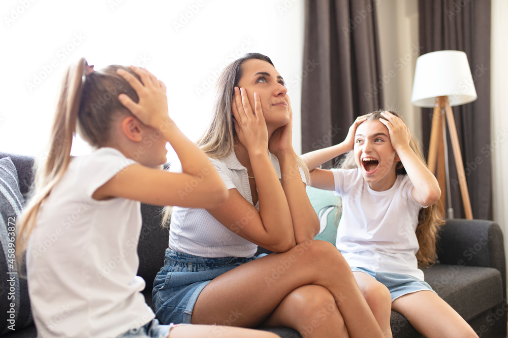 Tired single mother feeling stressed while stubborn child daughter ...