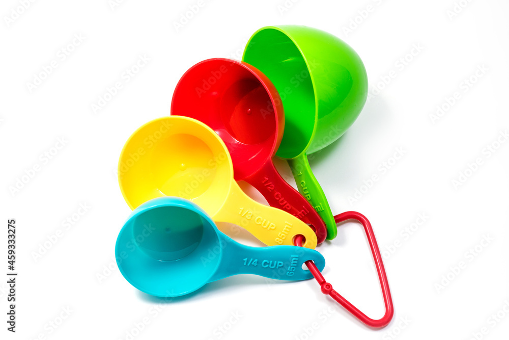 Four pieces of colorful ingredient measuring scoops or spoons of ...