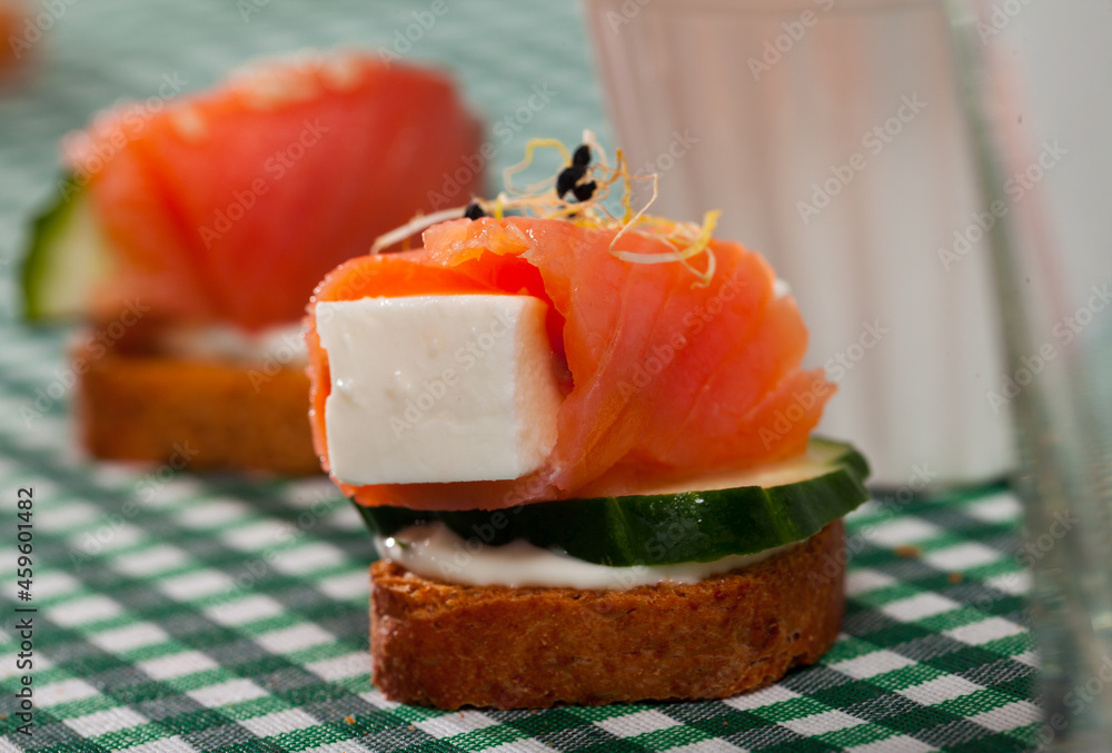 Delicious canape on toasted bread with smoked salmon, young cheese ...