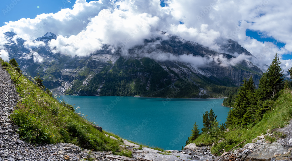 An attractive summer morning on the unique Oeschinensee Lake. A ...