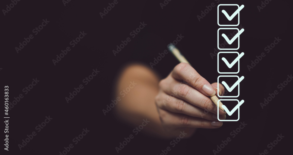 Marking on checklist box isolated on black background. Checklist ...