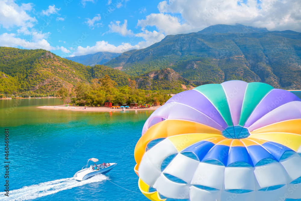 Foto de Stock Colorful parasail wing pulled by a boat in the sea ...