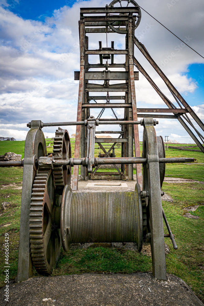 The metal pit-head winding wheel, cage & headgear above the main shaft ...