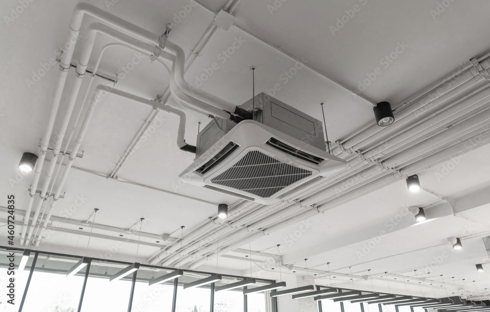 Modern white ceiling mounted cassette type air conditioner in office ...