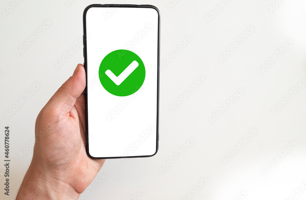 green check mark on smartphone screen. green checkmark showing approved ...