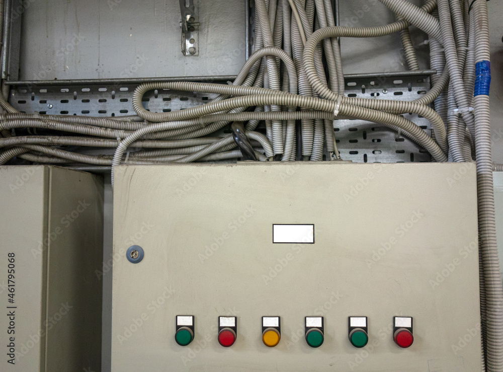 Metal electrical panel with multicolored buttons and wires. Electrical ...