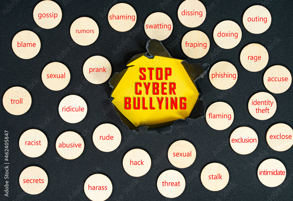 Layout of torn paper with text STOP CYBER BULLYING and wooden tiles ...