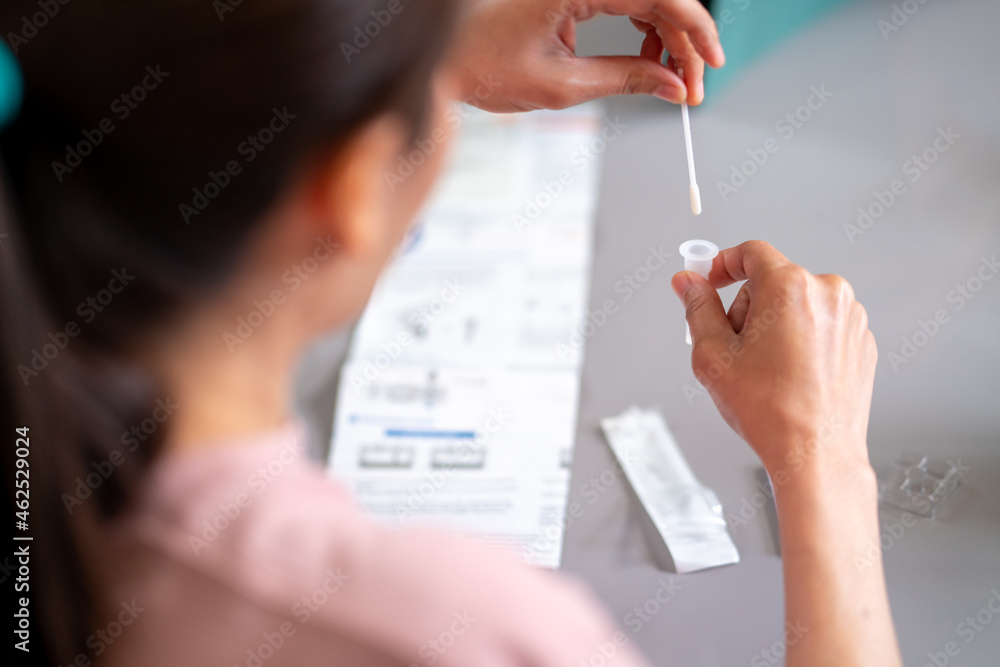 Asian woman using rapid antigen test kit for self test COVID-19 ...