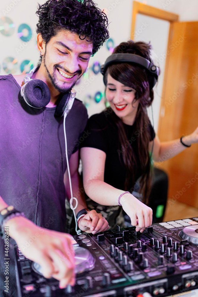 Happy DJing couple mixing sound together at recording studio Stock ...