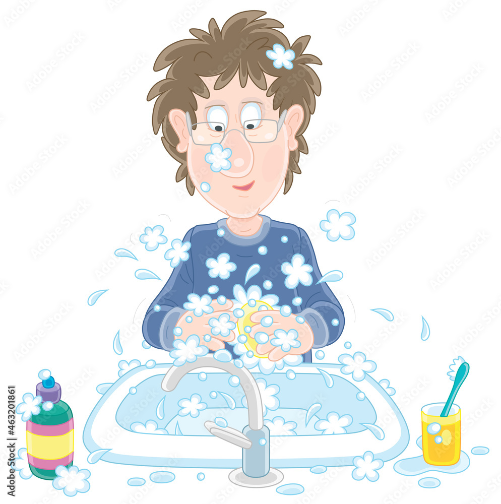 Funny young man with disheveled hair washing his hands in a sink of a ...