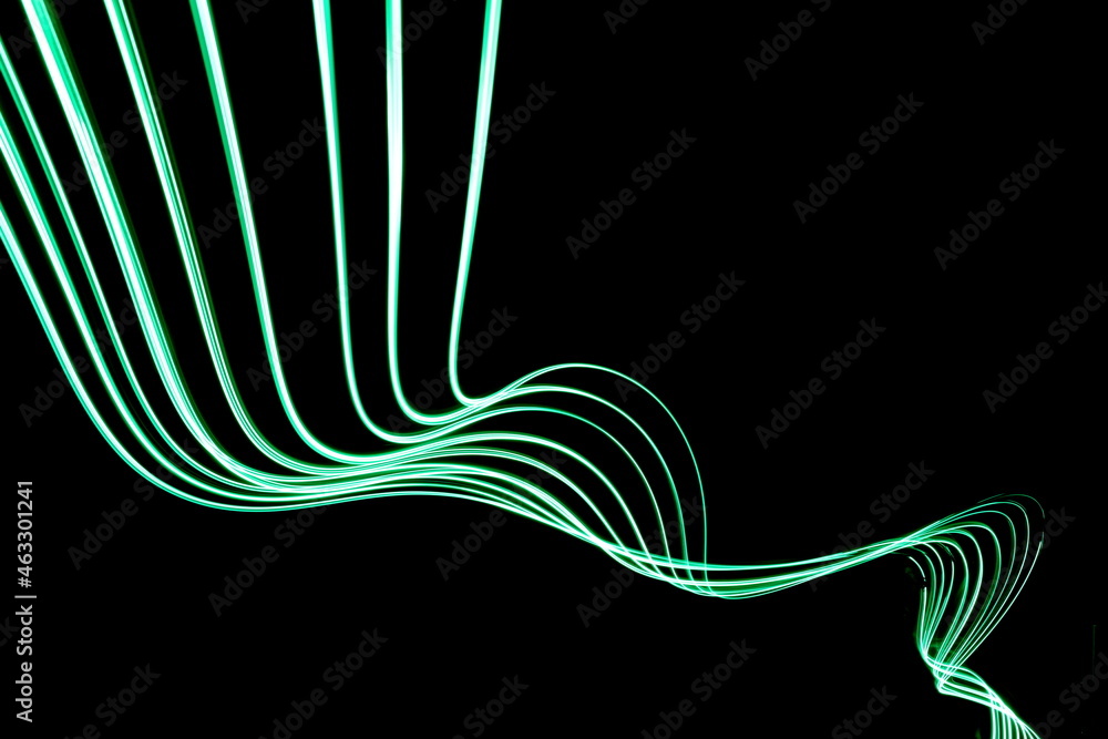 Long exposure photograph of neon colour in an abstract swirl, parallel lines pattern against a ...