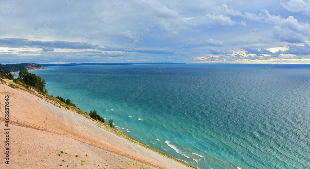 a stunning view across the turquoise-colored water of lake michigan and ...
