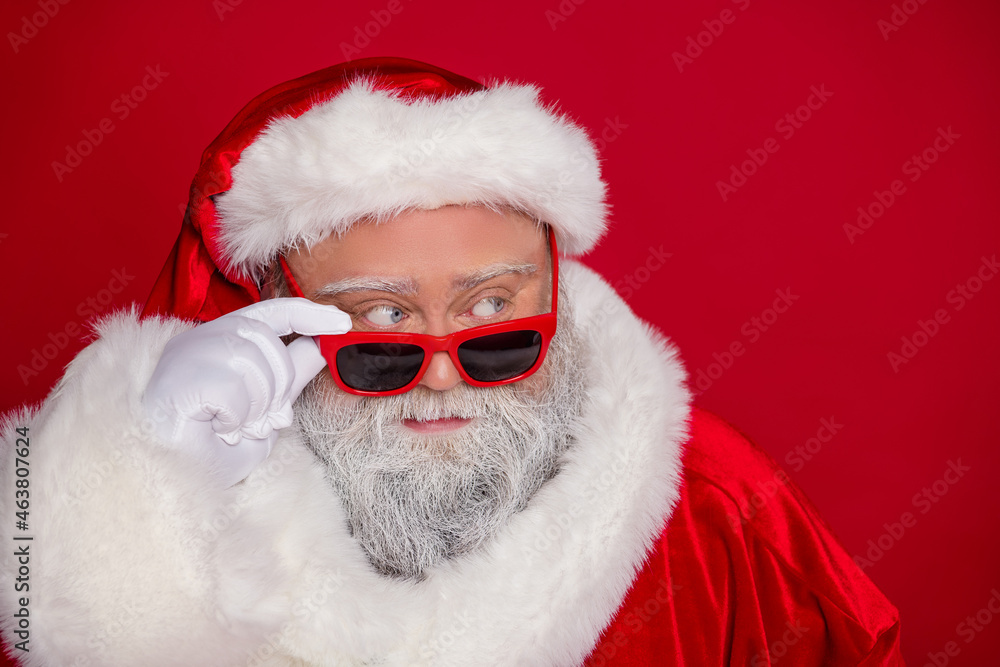 Portrait of attractive funny curious Santa touching specs north pole ...