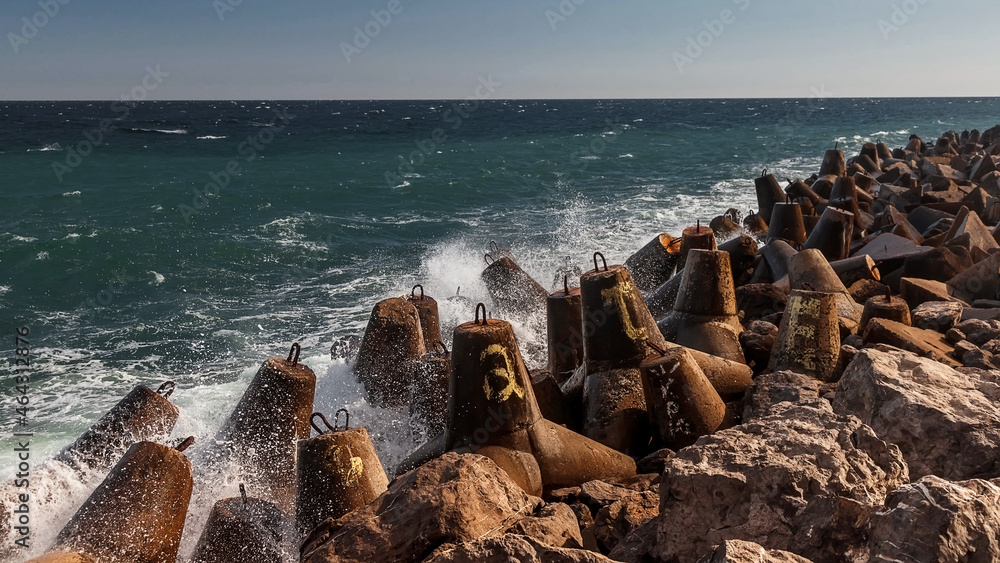 Strengthening the shore from erosion with concrete tetrapods. The ...