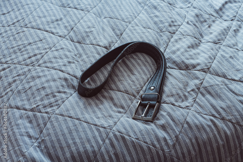 Leather belt on bed prepared for spanking. Domestic discipline ...
