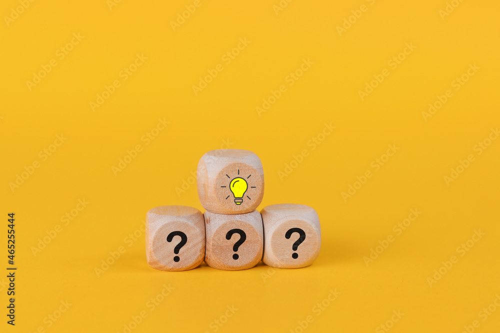 Question mark and light bulb on wooden blocks lined up. Ideas, question ...