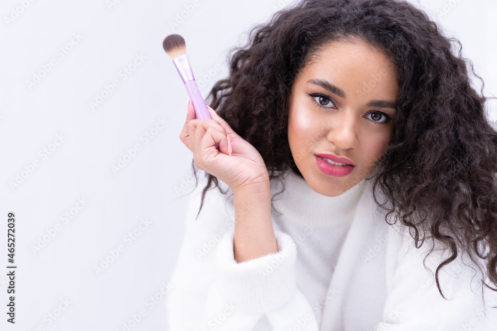 Head shot close up biracial young female applying daily makeup by ...