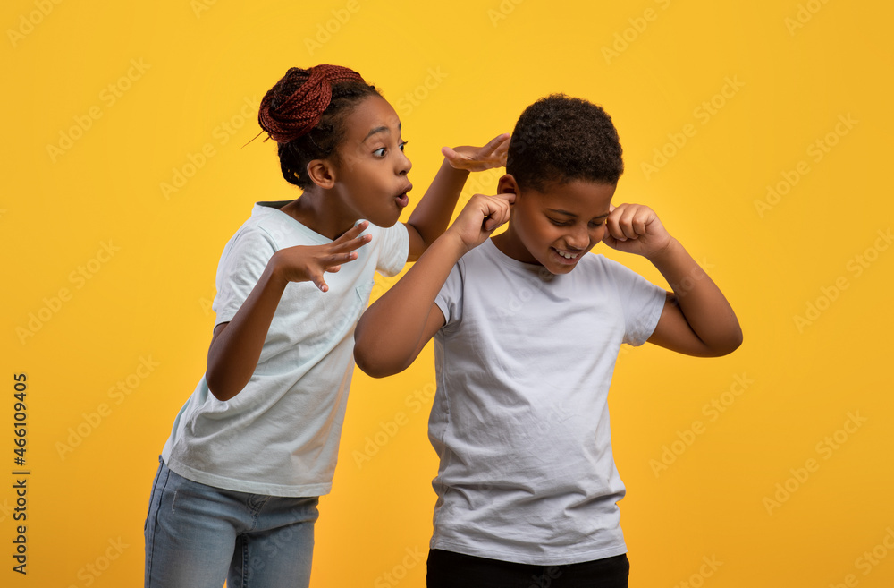 Photo Stock Annoying older sister scolding her little brother | Adobe Stock