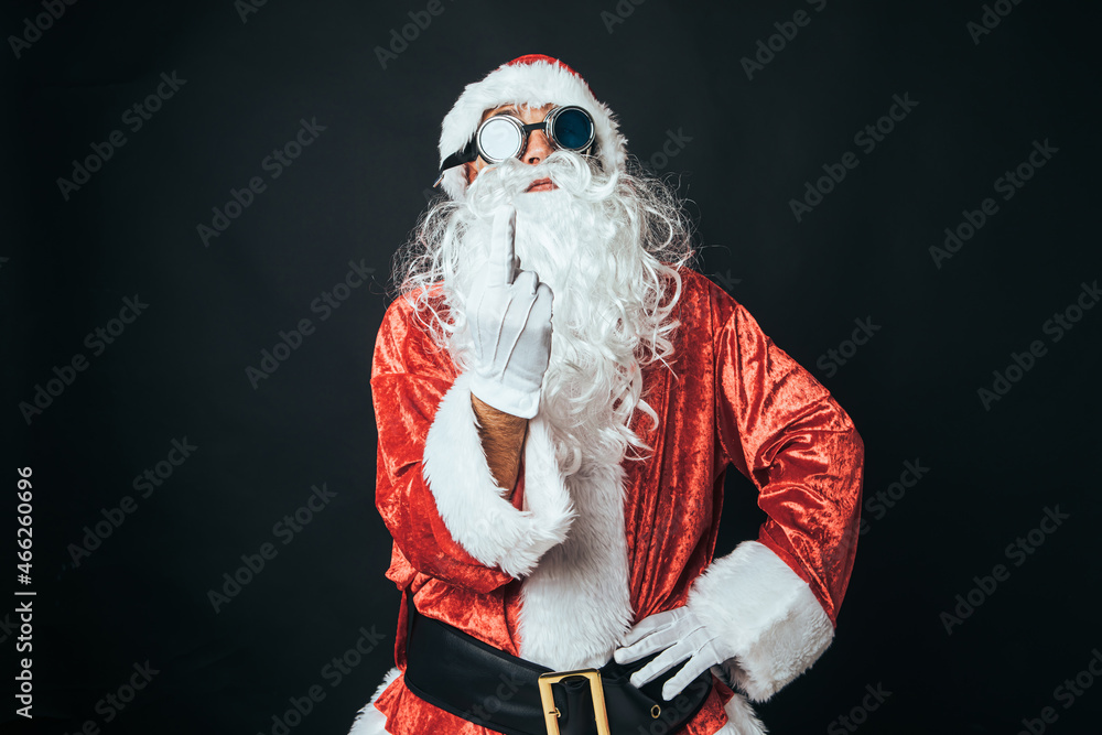 Man dressed as Santa Claus making a rude gesture, raises his finger as ...