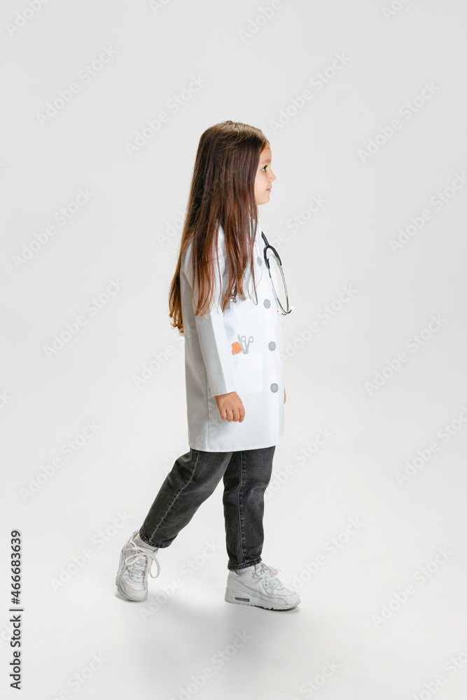 Side view. Cute beautiful little girl, child in image of doctor wearing ...