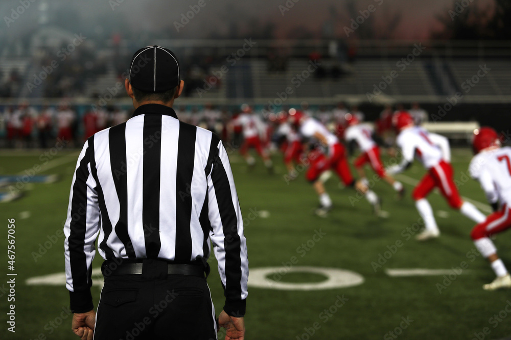 A football official watches the kick-off Stock Photo | Adobe Stock