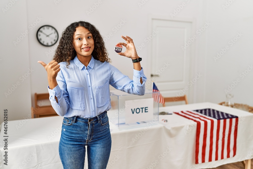 Beautiful hispanic woman standing by at political campaign by voting ...