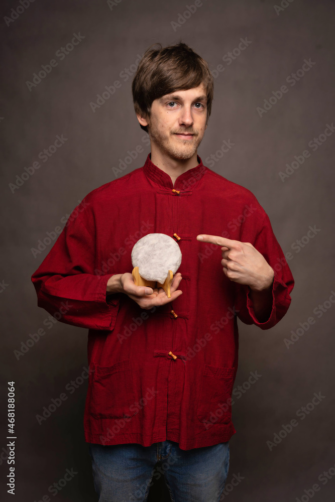 Young handsome tall slim white man with brown hair pointing at pu erh ...