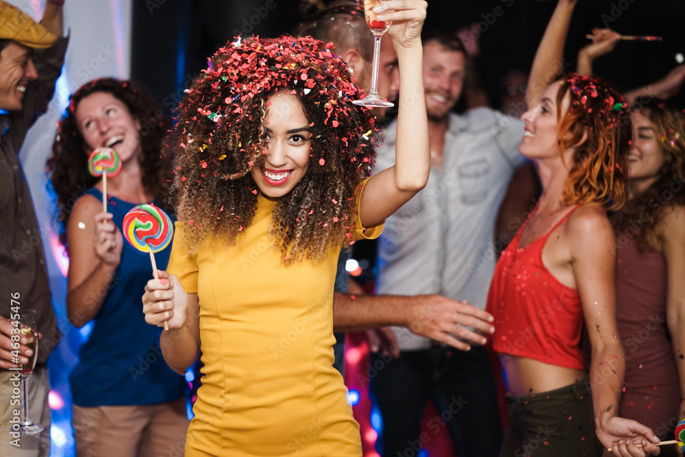 Young multiracial friends having fun cheering and drinking champagne at ...
