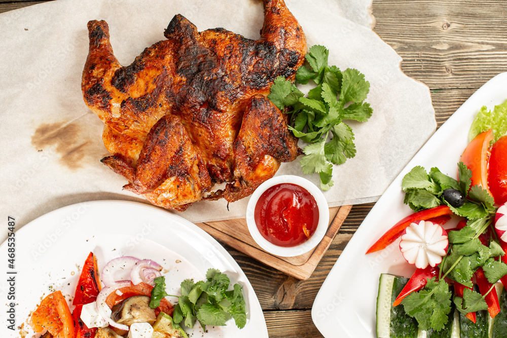 grilled chicken. Serving on a wooden Board on a rustic table. Barbecue ...